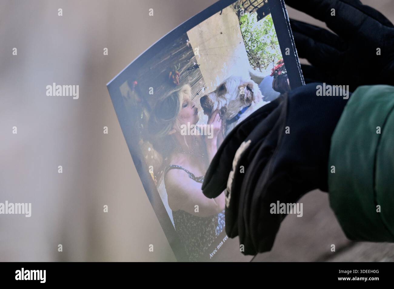 A person holds a photo of late actor Brigitte Bardot after her funeral ...