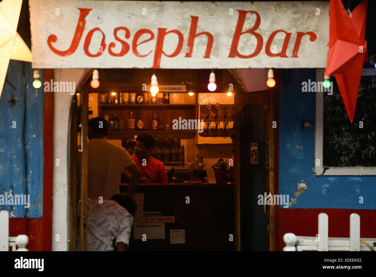 A barman stands at the bar counter in Joseph bar in Panjim, Goa, India ...