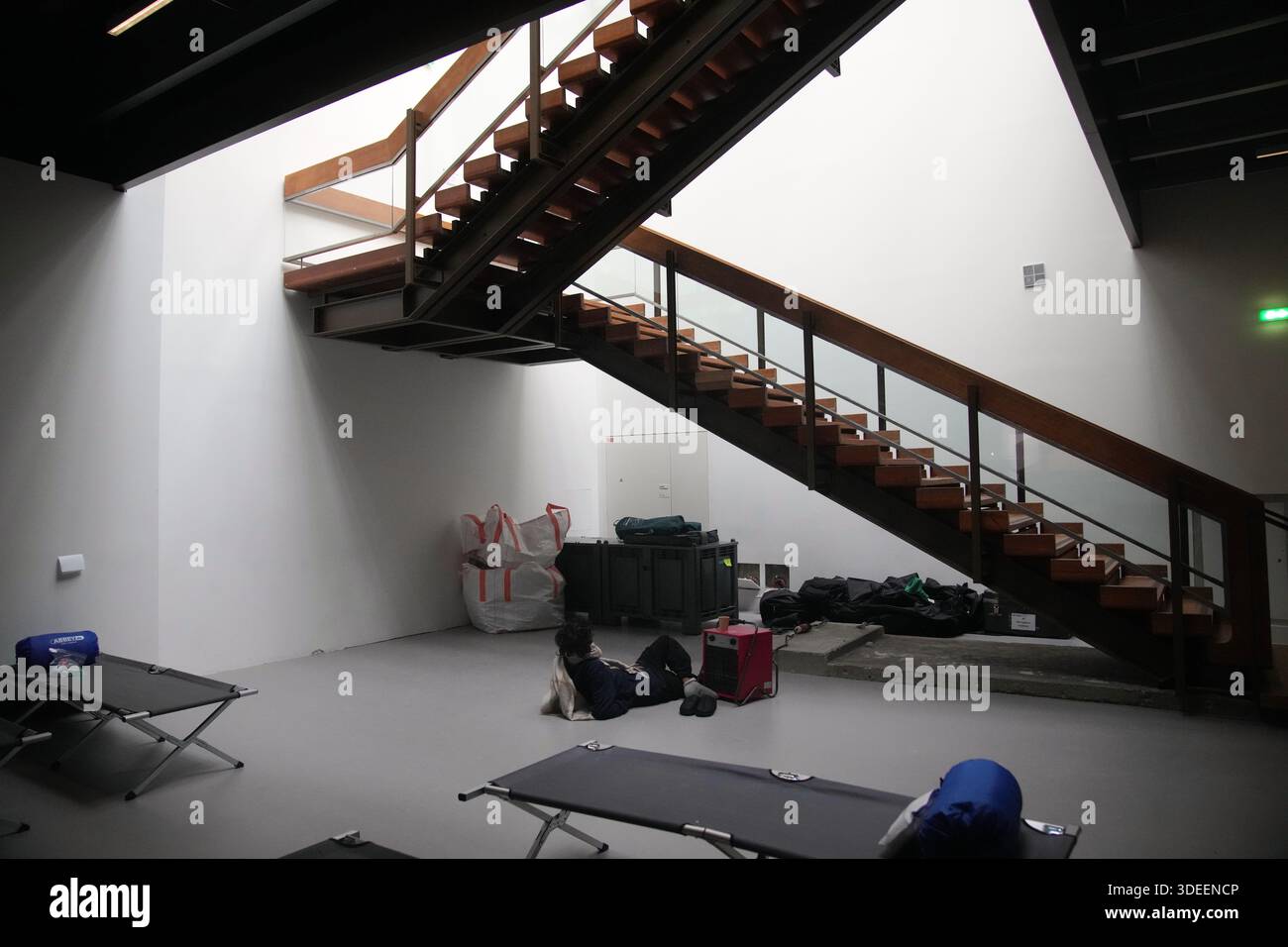 A homeless warms up in a shelter set up by the Red Cross in the Grand ...