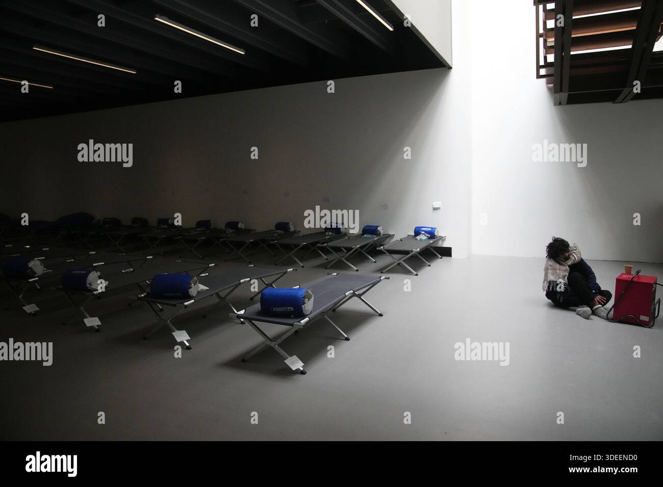 A homeless warms up in a shelter set up by the Red Cross in the Grand ...