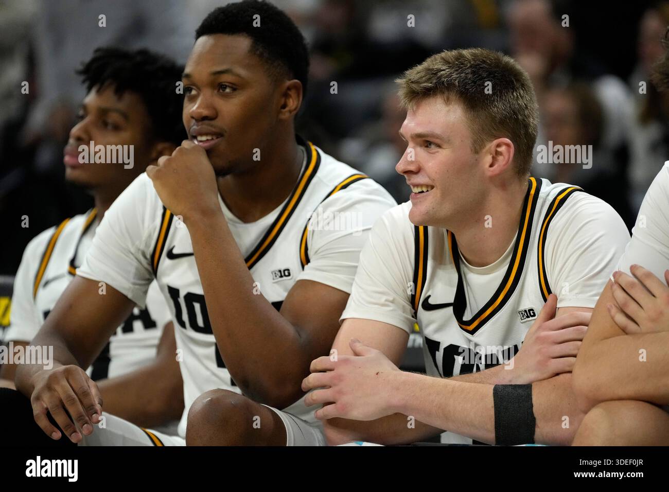 Iowa guard Bennett Stirtz, right, sits on the bench next to teammate ...