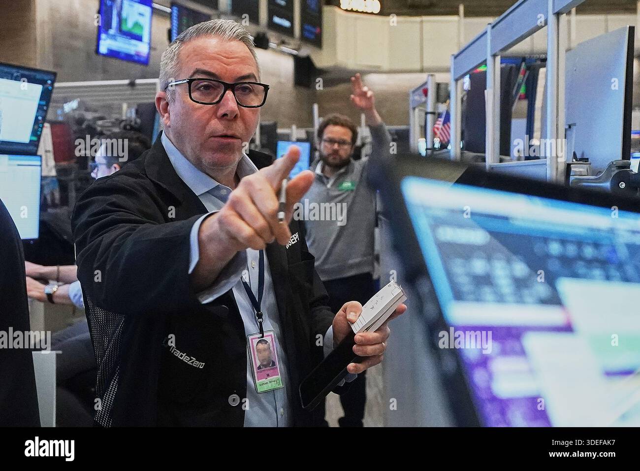 Options trader Joseph D'Arrigo works on the floor of the New York Stock ...