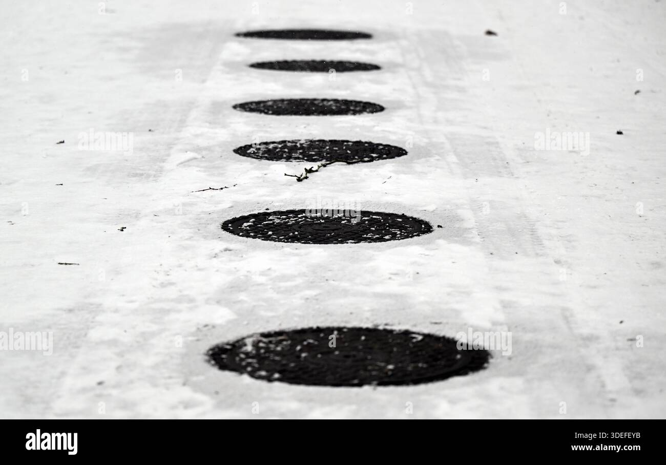 Manhole covers in a snowy landscape taken from the top of the Citradel ...