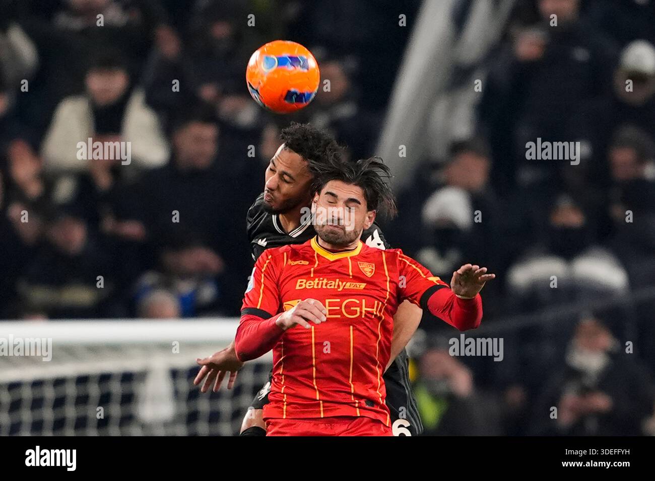 Juventus' Lloyd Kelly jumps for the ball with LecceÕs Jamil Siebert ...