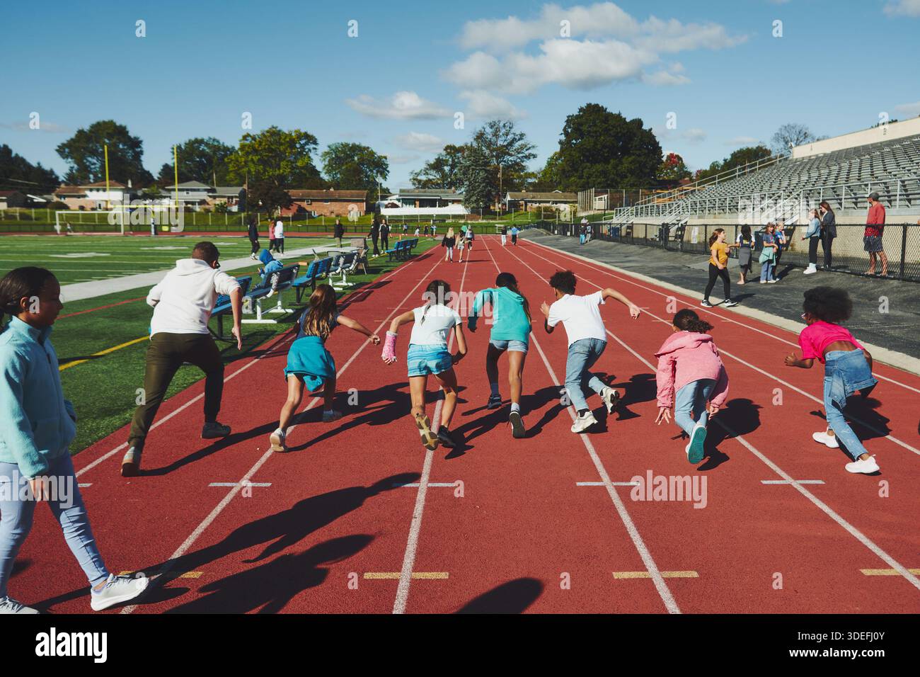 A group of children sprinting from the starting line on an outdoor ...
