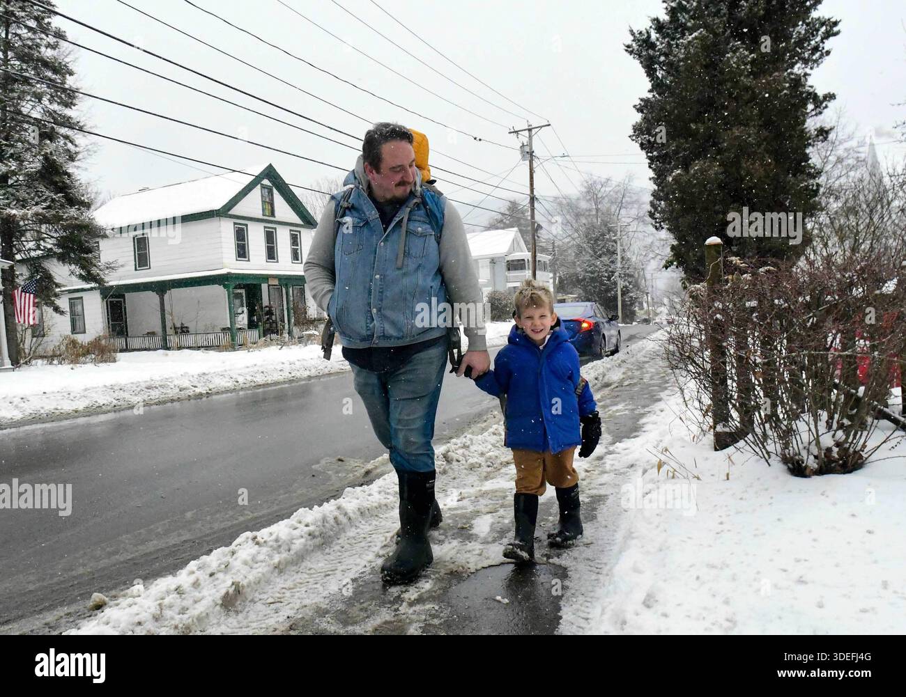 Nick Delaini of Brattleboro, Vt., walks his son, Lee, 5, a ...