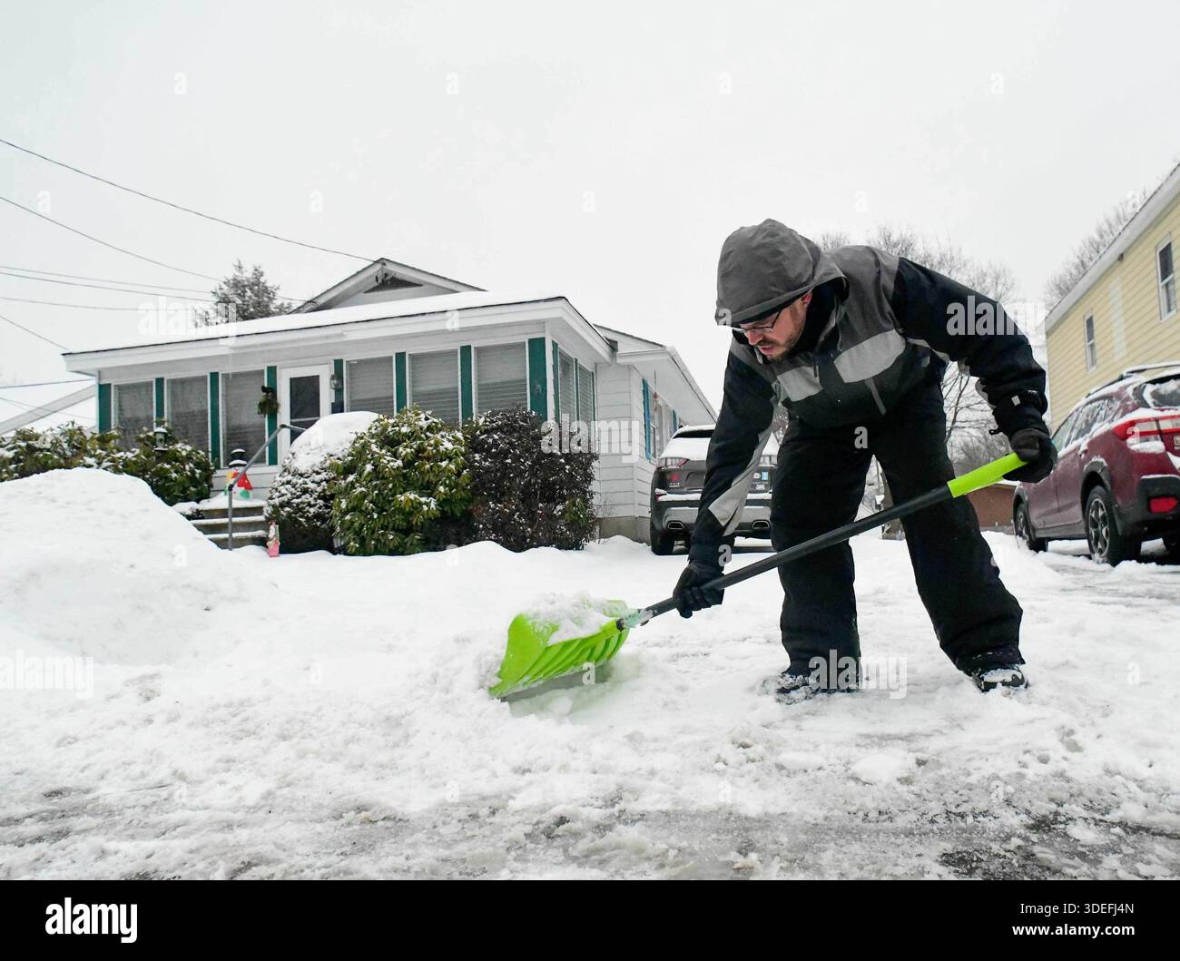 Jordan Barkow of Brattleboro, Vt., shovels after a wintry mess passed ...
