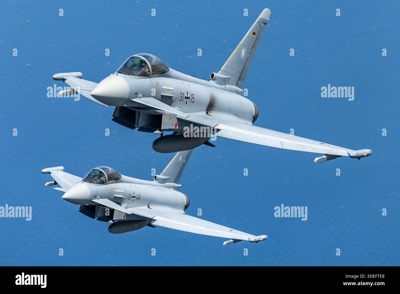 Two Luftwaffe Eurofighter EF-2000 Typhoon S jets fly in formation over ...