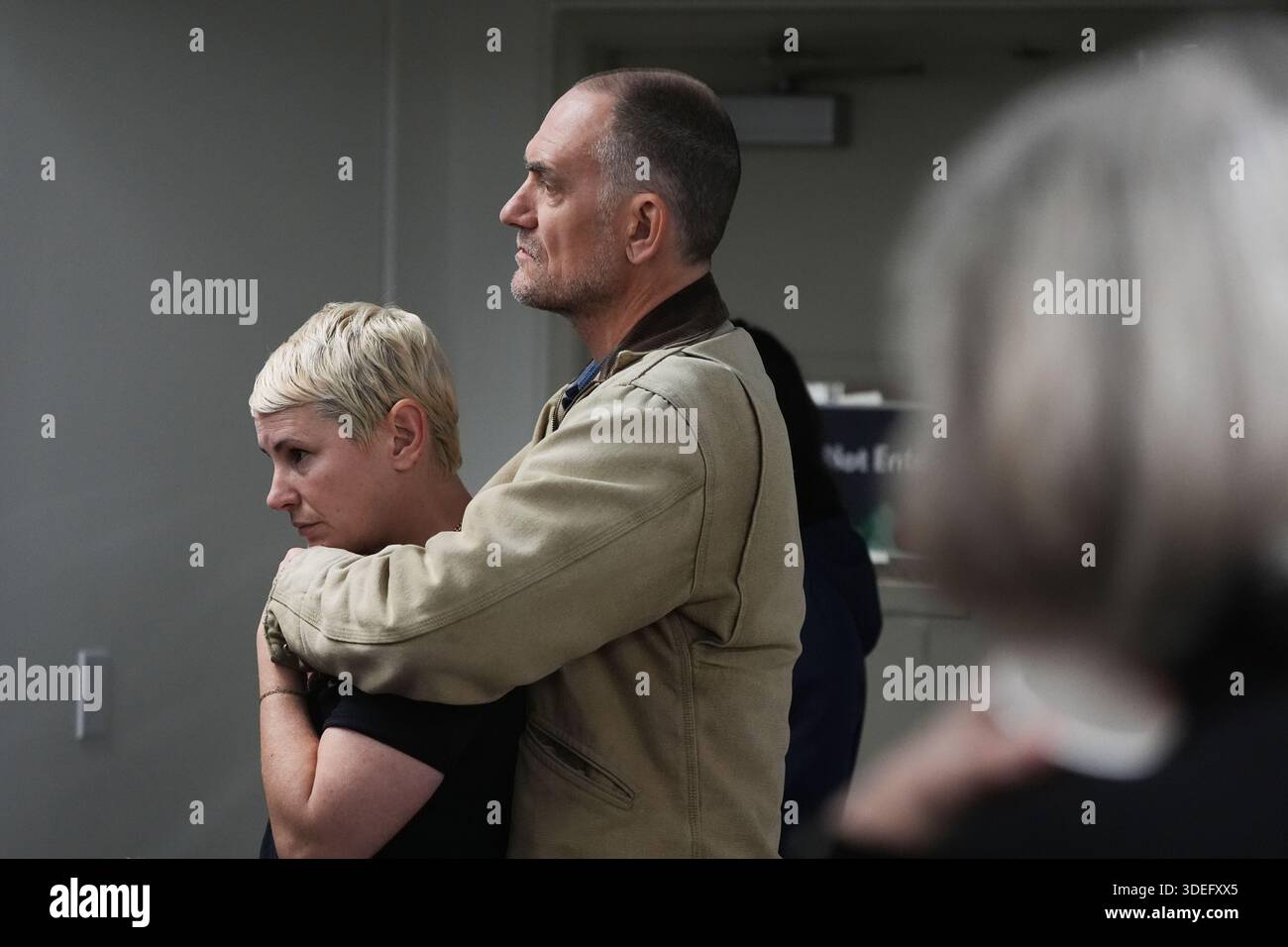 Eleanor Godfrey, left, is hugged by her husband Seth Morris during a ...