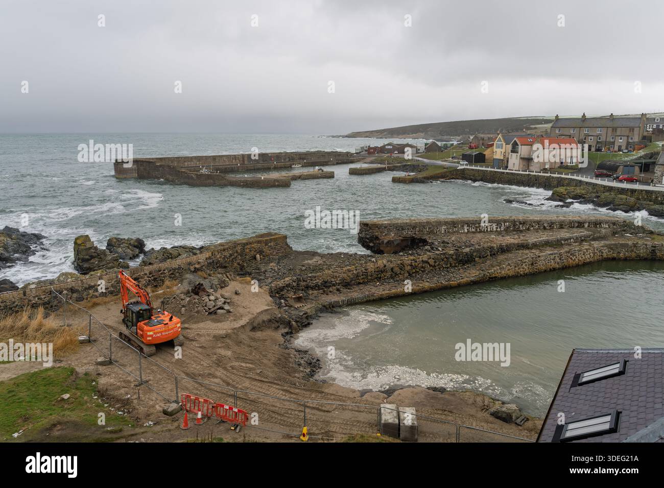 The exterior wall of the old part of Portsoy Harbour shows damage from ...