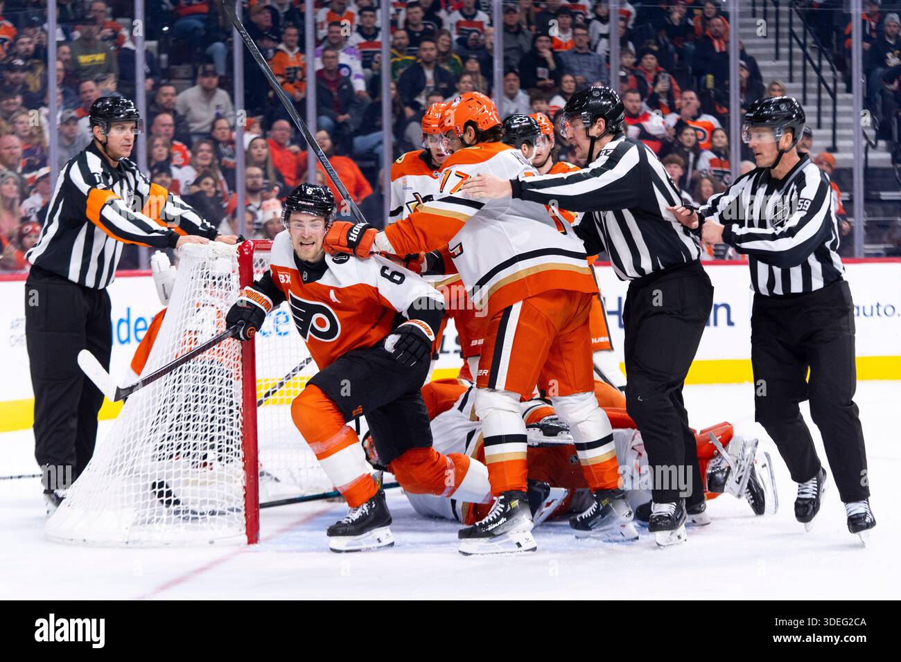 Philadelphia Flyers' Travis Sanheim, second from left, gets pushed by ...