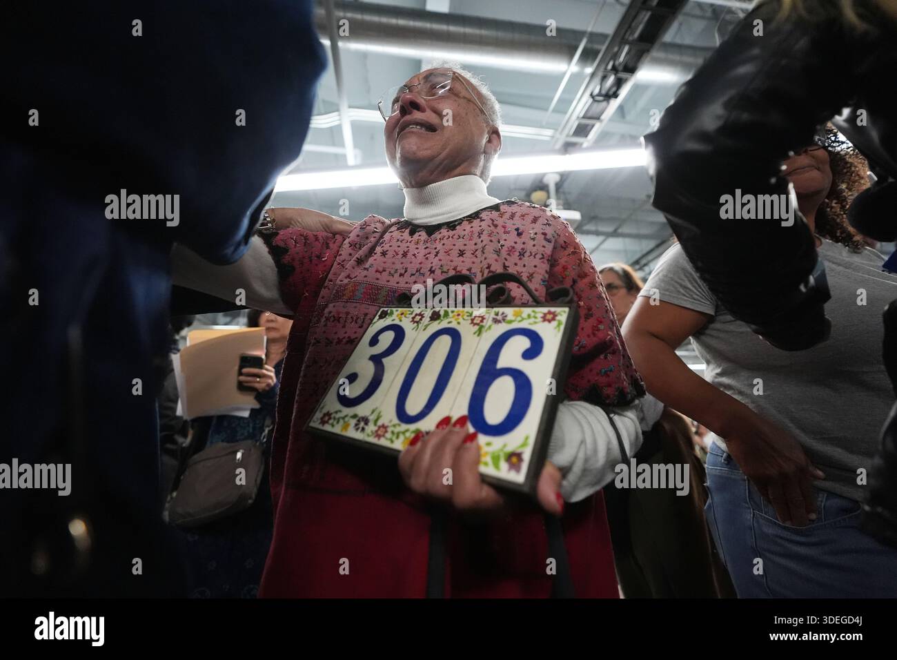 Jill Genzon holds a placard with her home address, which she lost in ...