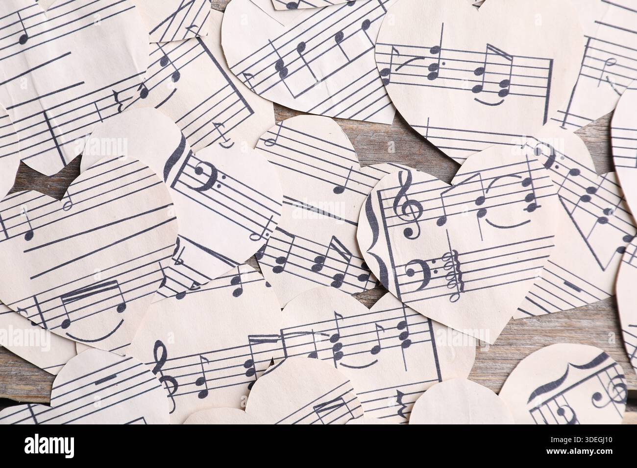 Heart shaped paper sheets with music notes on table, top view Stock ...