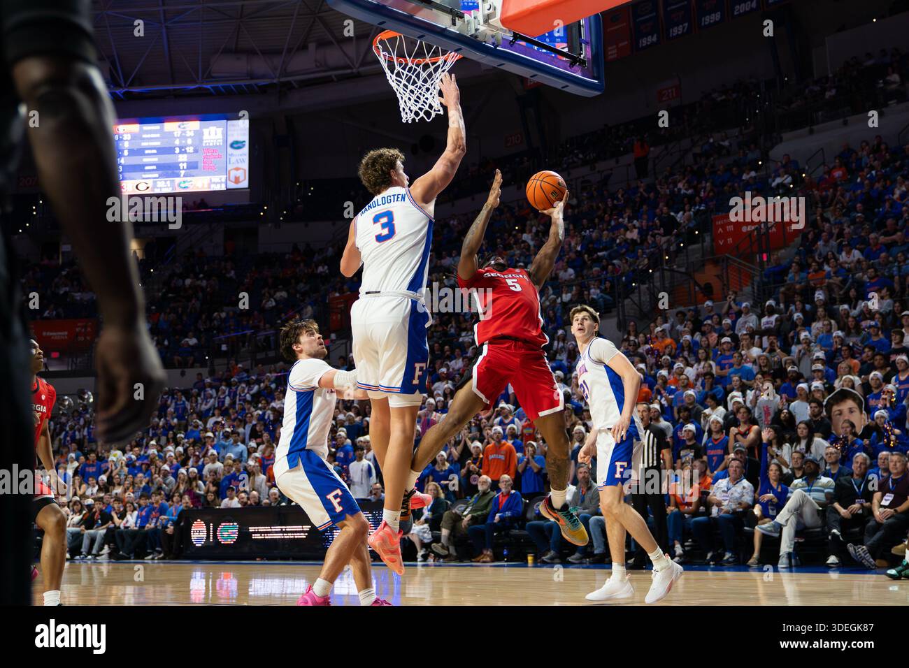 Georgia guard Jeremiah Wilkinson (5) jumps to dunk as Florida center ...