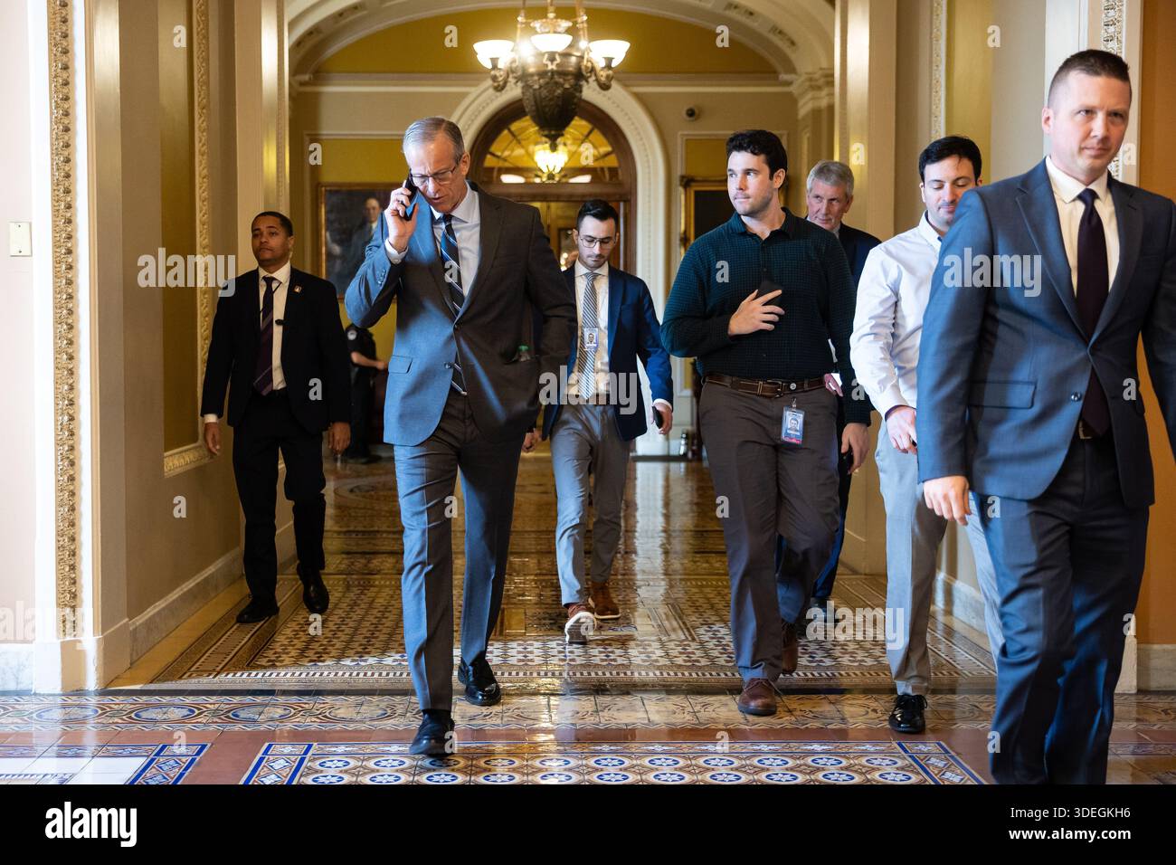 Senate Majority Leader John Thune (R-S.D.) speaks on a phone as he ...