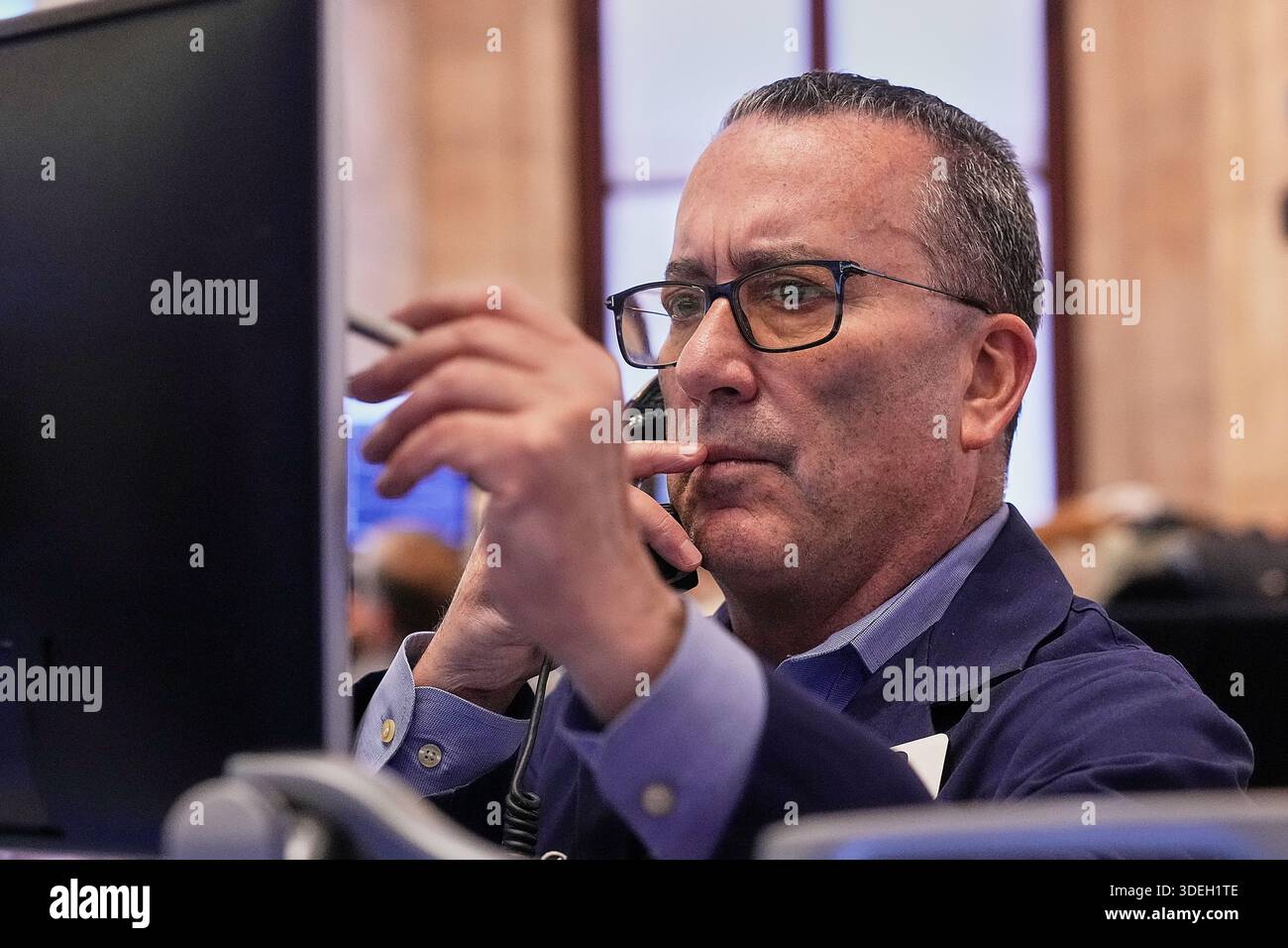 Trader David Fox works on the floor of the New York Stock Exchange ...