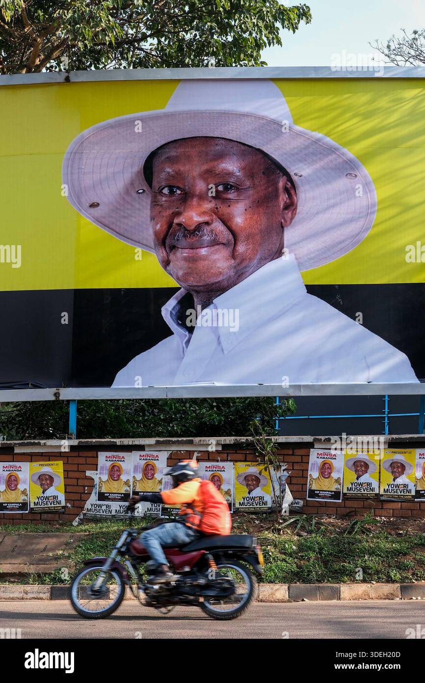 A motorist passes President Yoweri Museveni's campaign billboard in ...