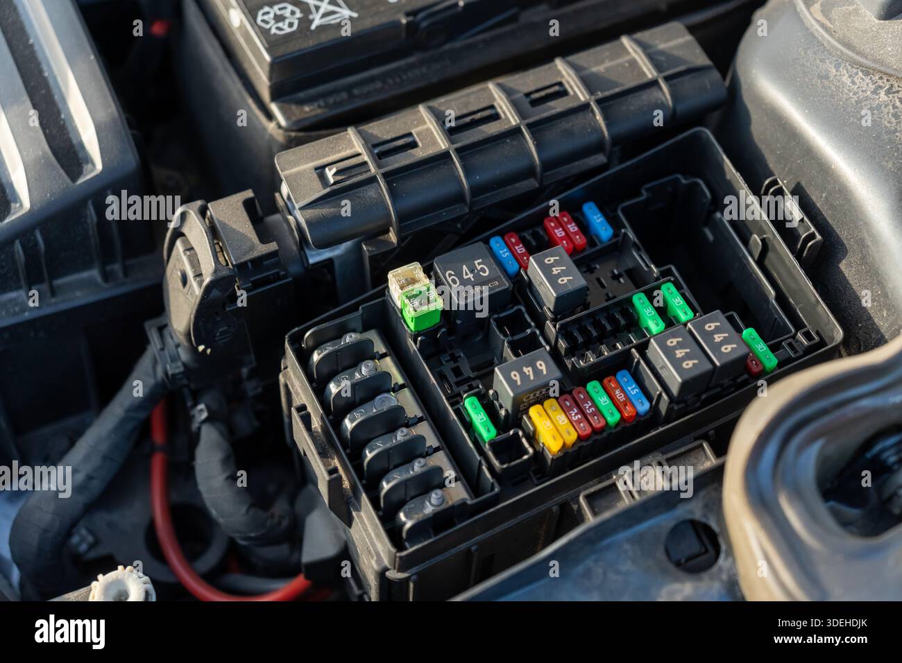 Open automotive fuse box in engine compartment with colorful blade ...