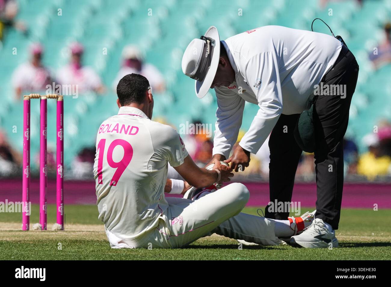 Australia's Scott Boland is assisted by umpire Ahsan Raza during play on the last day of the ...