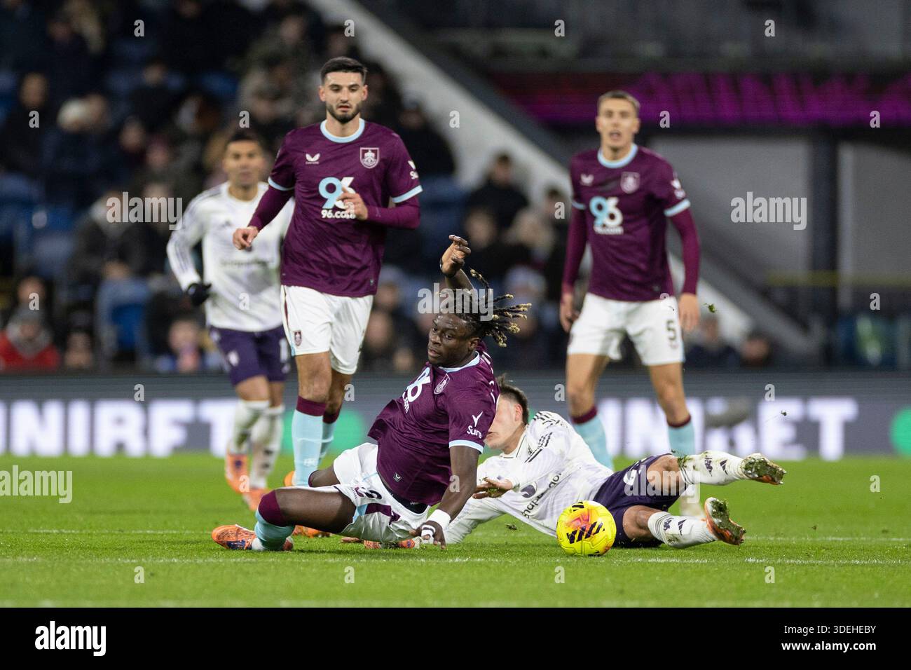 Lesley Ugochukwu #8 of Burnley F.C is fouled by Manuel Ugarte #25 of ...
