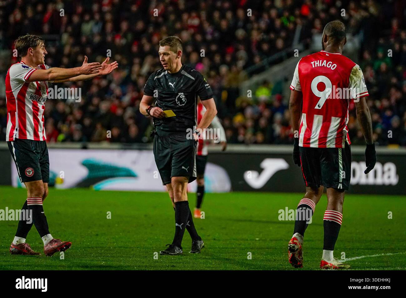 Referee Matthew Donohue shows a yellow card during the Premier League ...