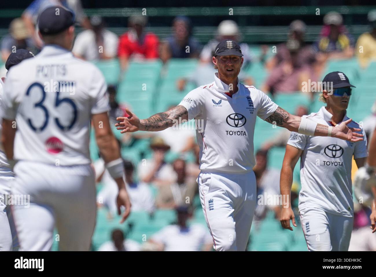 England's Ben Stokes gestures to his teammates during play on the last ...