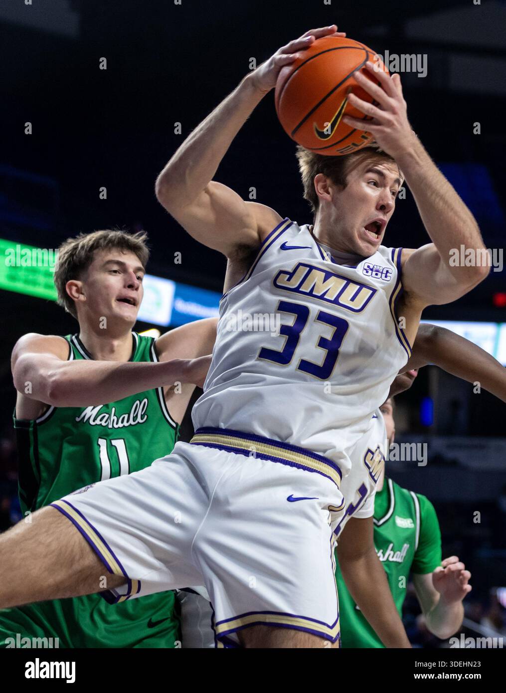 James Madison forward Gabe Newhof (33) grabs a rebound against Marshall ...