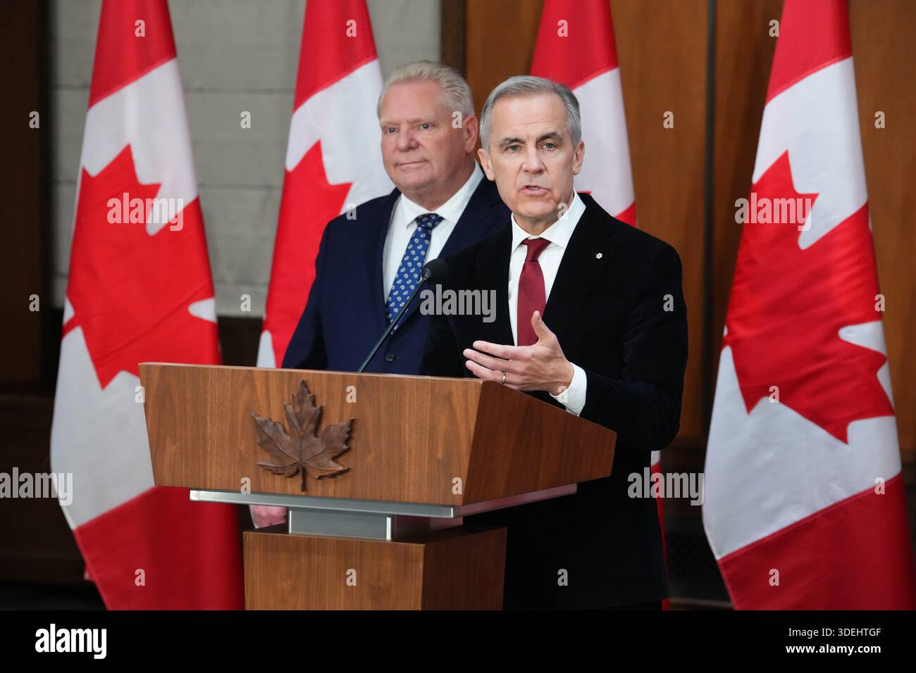 Prime Minister Mark Carney, right, and Ontario Premier Doug Ford hold a ...