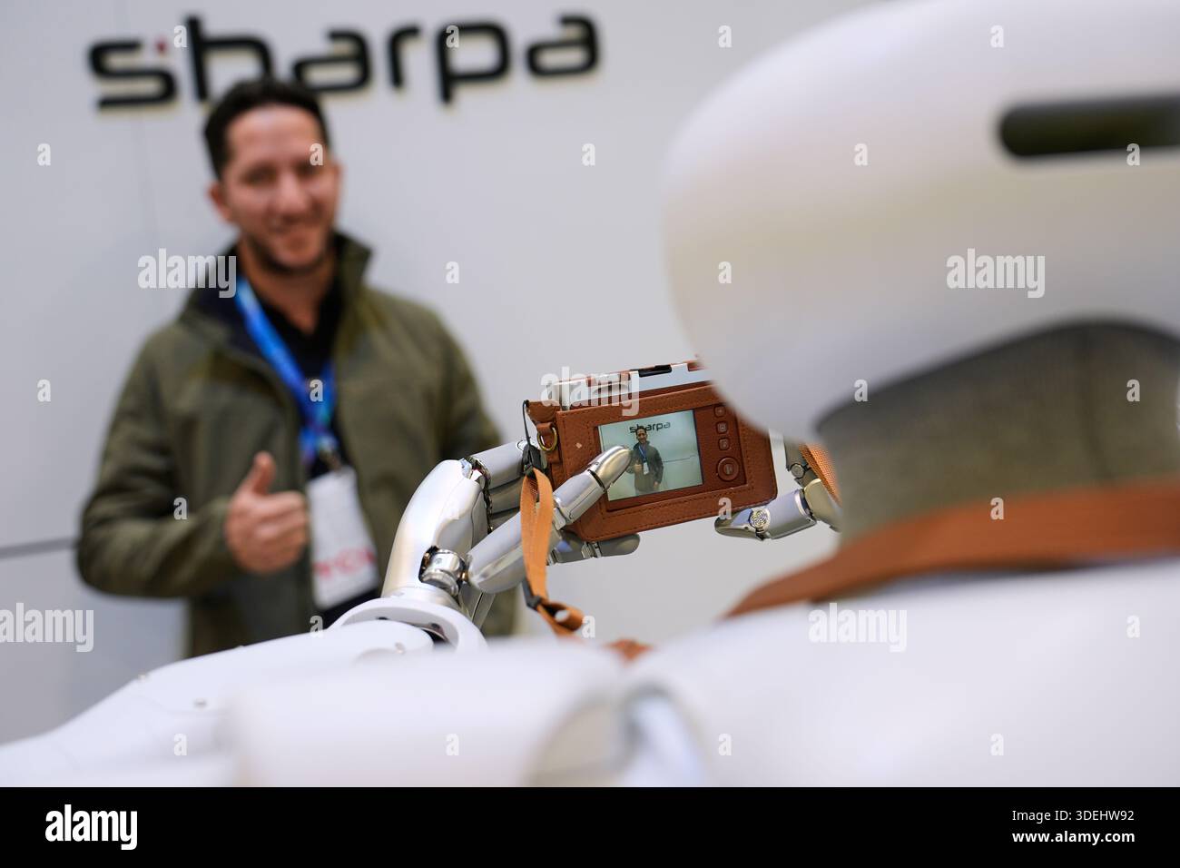 The Sharpa North robot, foreground, takes a photograph of an attendee ...