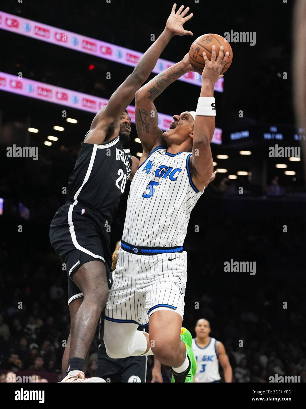 Orlando Magic's Paolo Banchero (5) shoots over Brooklyn Nets' Day'ron ...