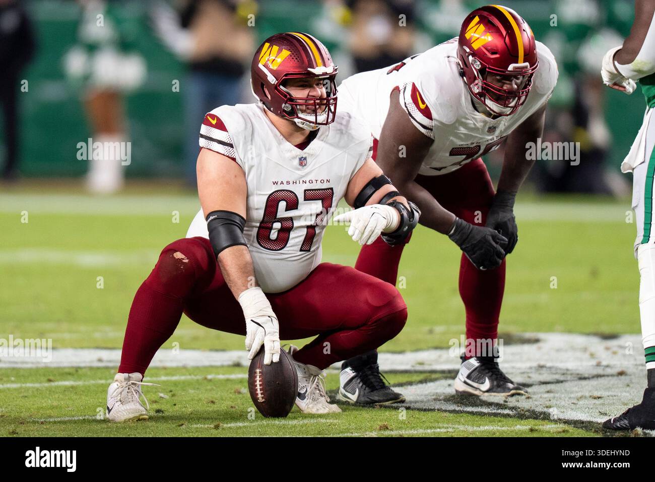 Washington Commanders center Nick Allegretti, left, looks on with guard ...