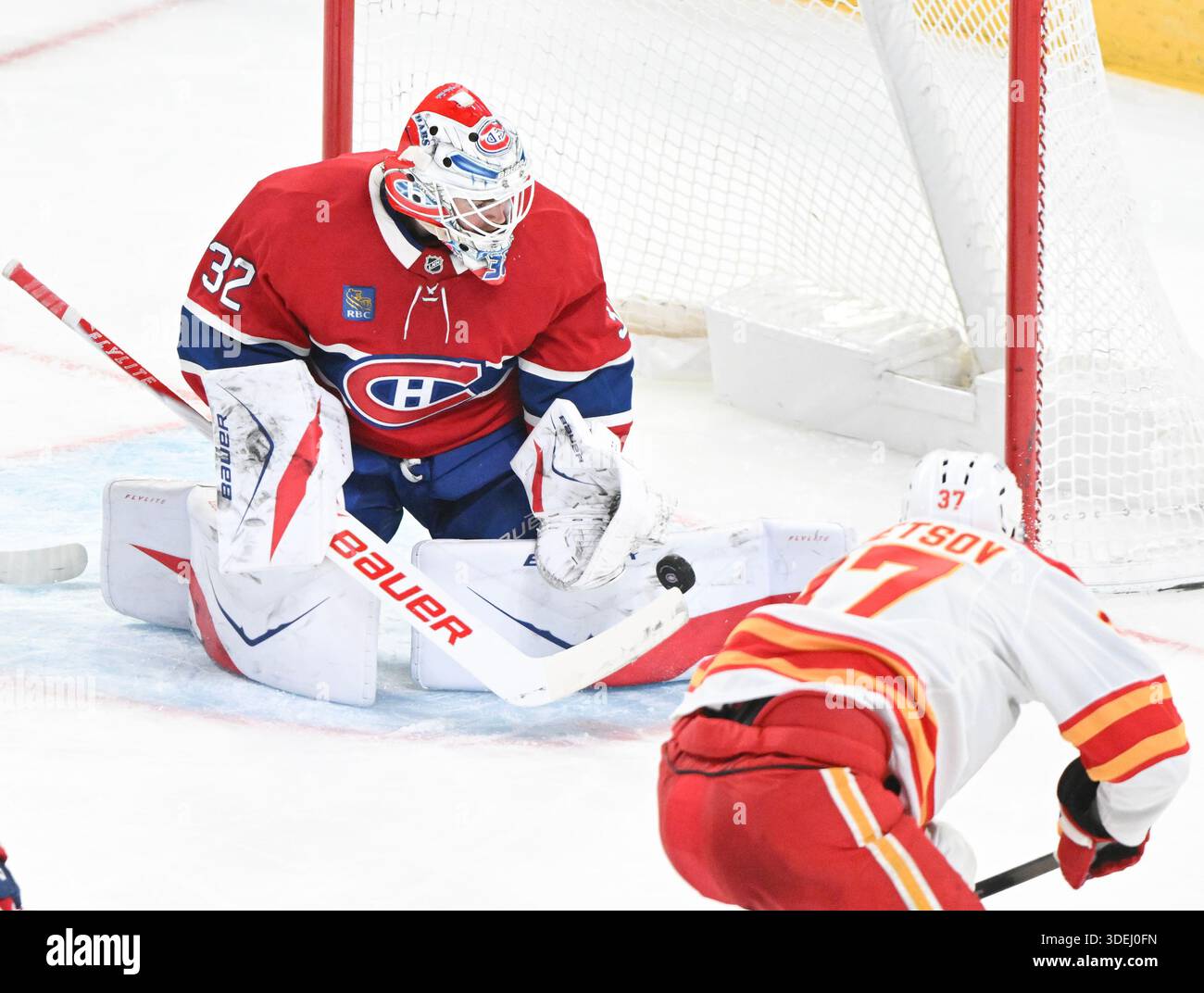 Montreal Canadiens goaltender Jacob Fowler (32) stops Calgary Flames ...