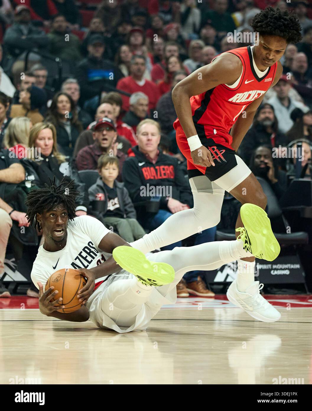 Portland Trail Blazers guard Sidy Cissoko, left, dives for a loose ball ...