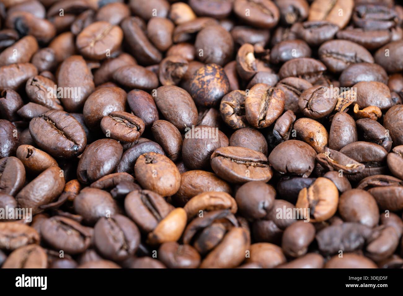 Close-up medium roasted coffee beans revealing subtle color variations ...