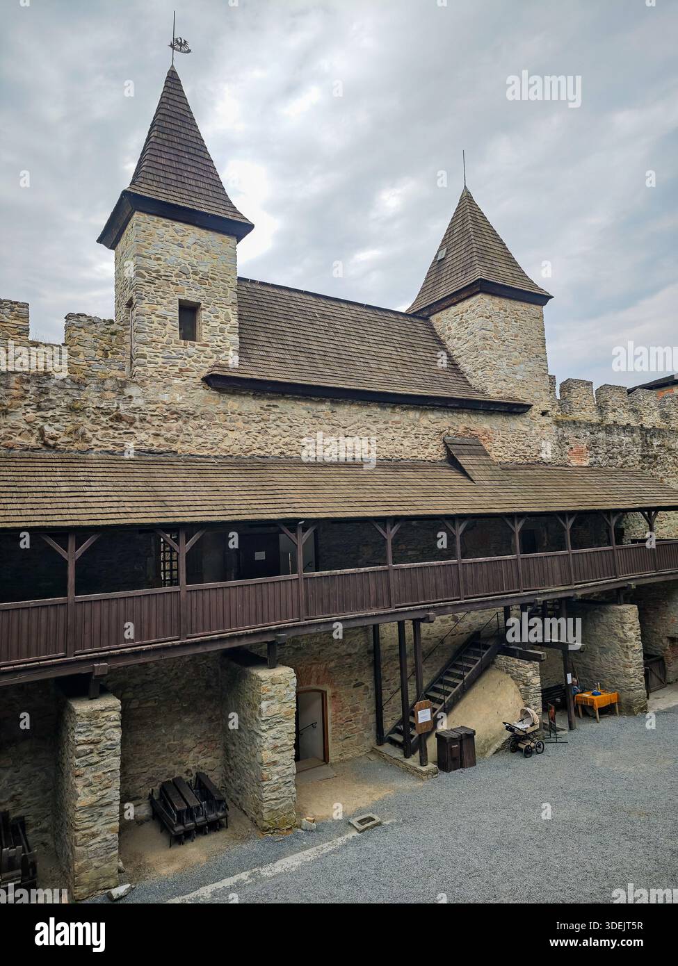 Traditional wooden galleries and towers of a medieval castle courtyard ...