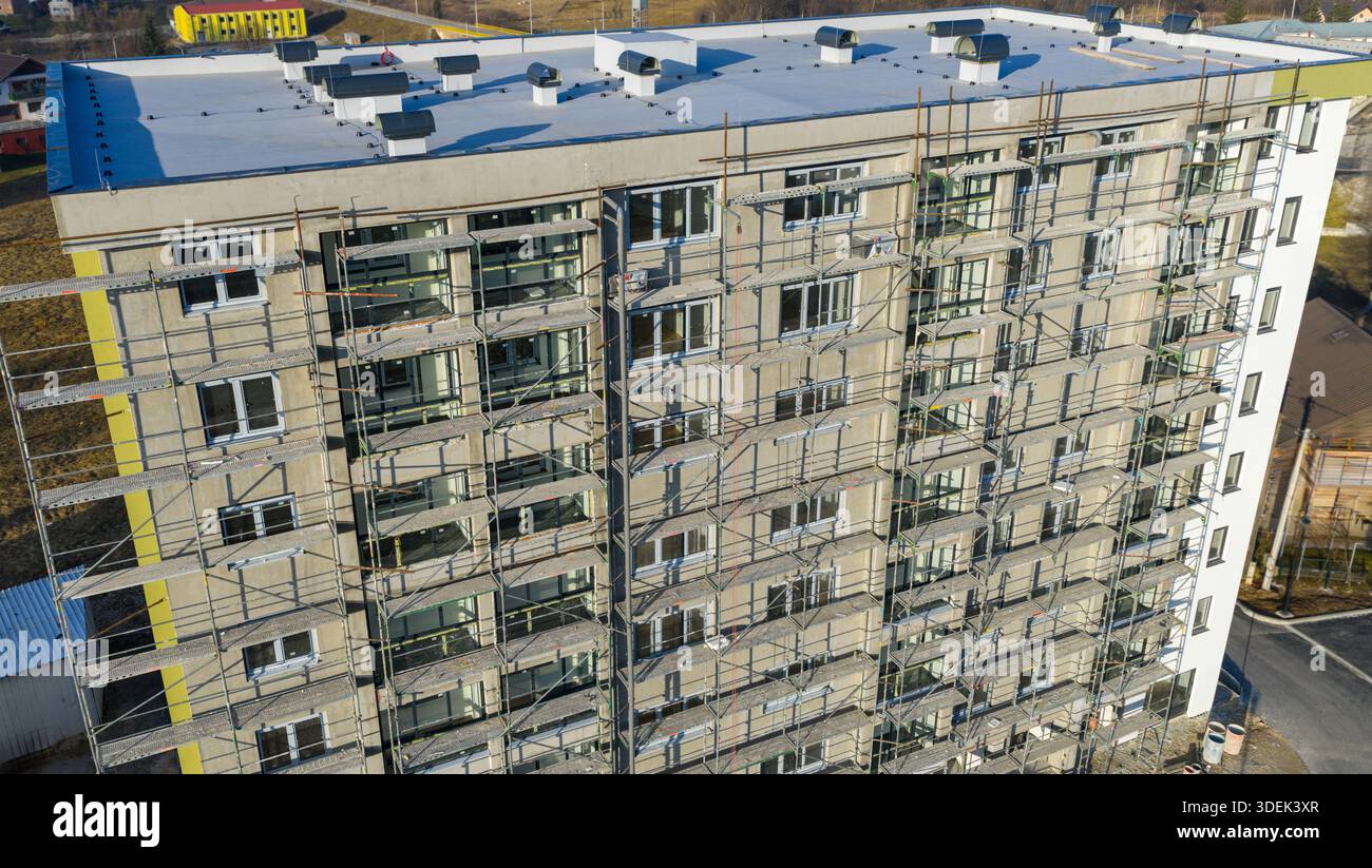 Side view of newly built apartment building with completed facade and ...
