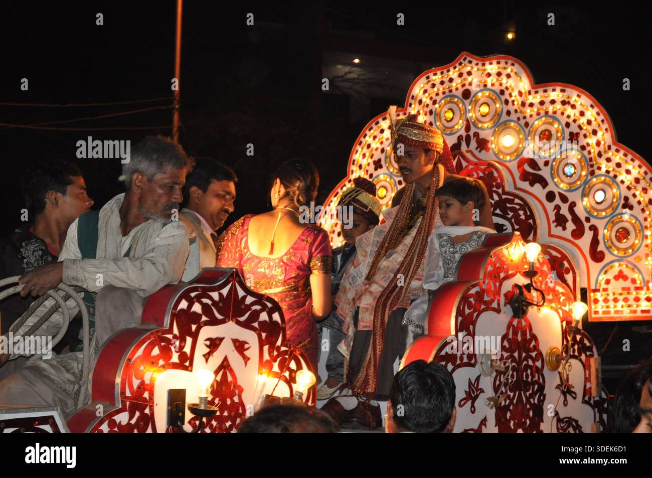 Traditional Indian wedding procession with bride and groom riding in ...
