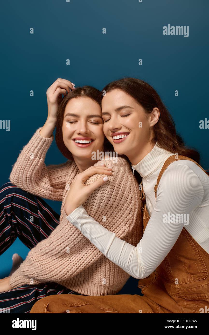 Twin sisters laugh embrace hi-res stock photography and images - Alamy