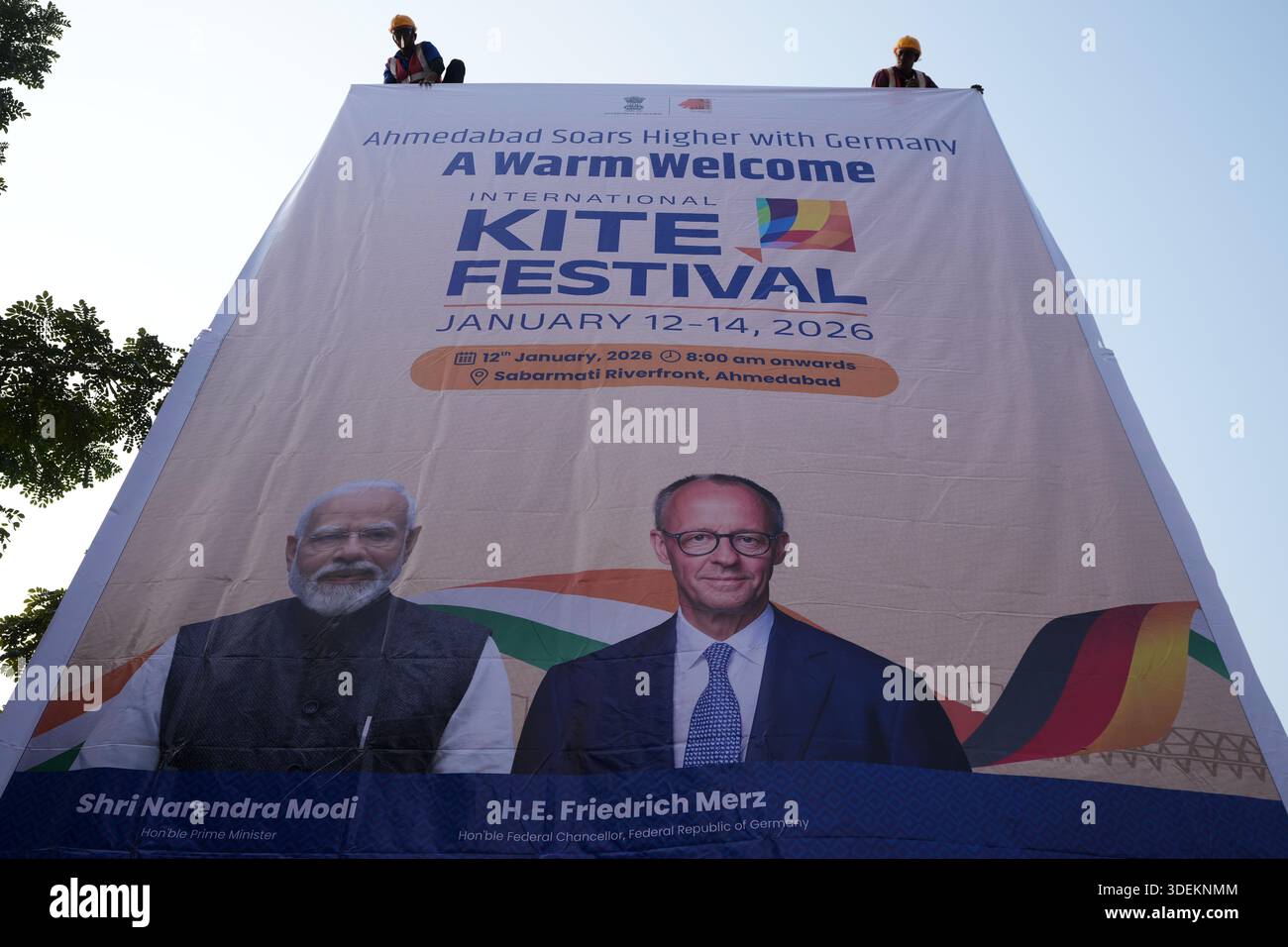Workers install a hoarding welcoming German Chancellor Friedrich Merz ...