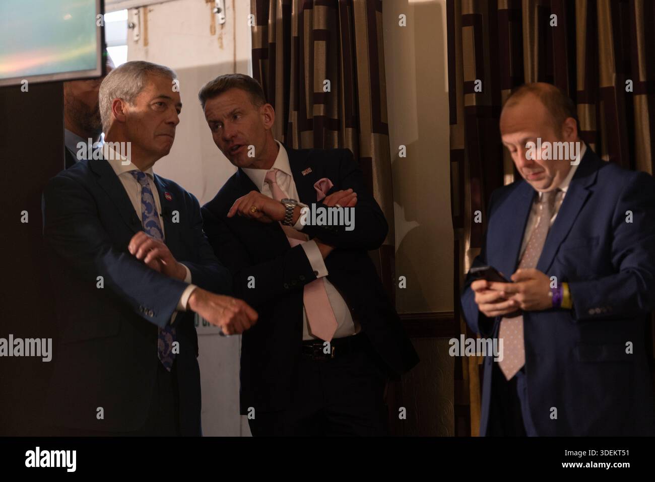 Nigel Farage (left) talking with David Bull (centre), at a Reform UK ...