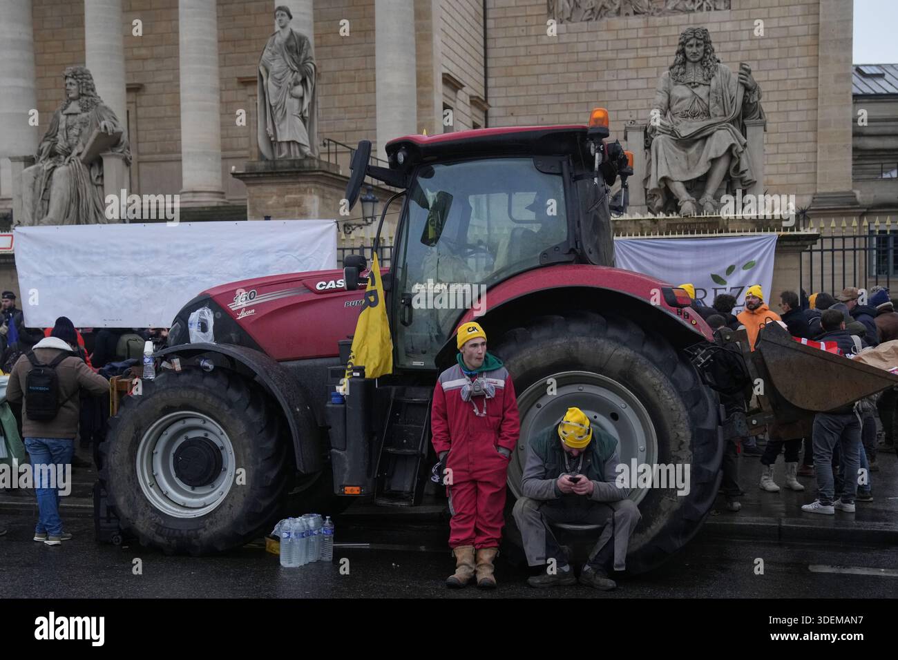 Farmers rest outside the National Assembly protest the European Union ...