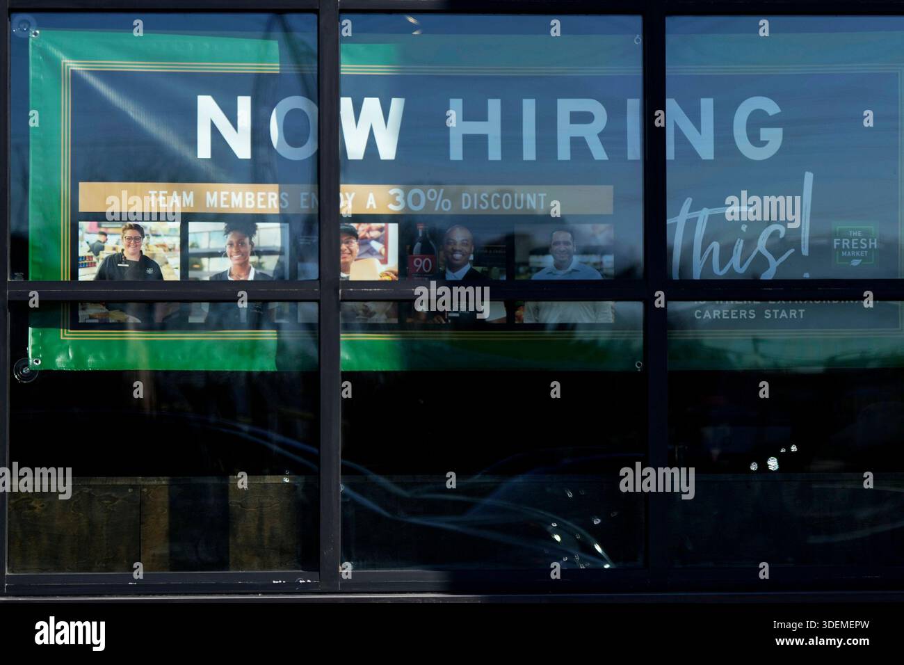 FILE - A hiring sign is displayed at a grocery store in Northbrook, Ill ...