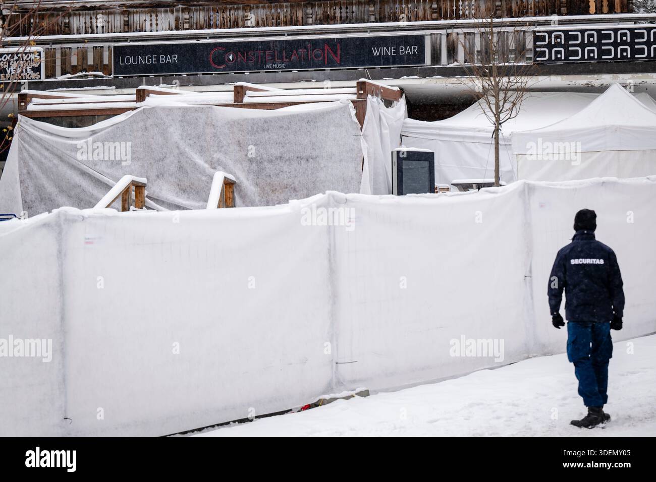 A security guard is watching the entrance of "Le Constellation" bar and ...