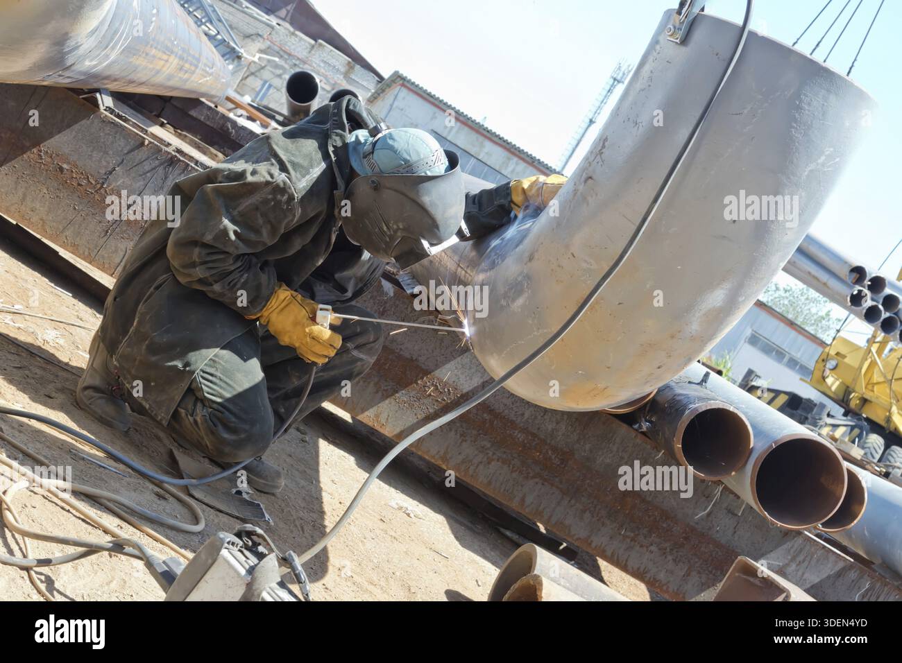 Welder is repairing the defective area of the weld inside the parts of ...