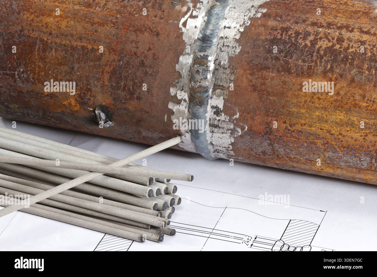 Electrodes for manual arc welding lie on the background of the welded ...