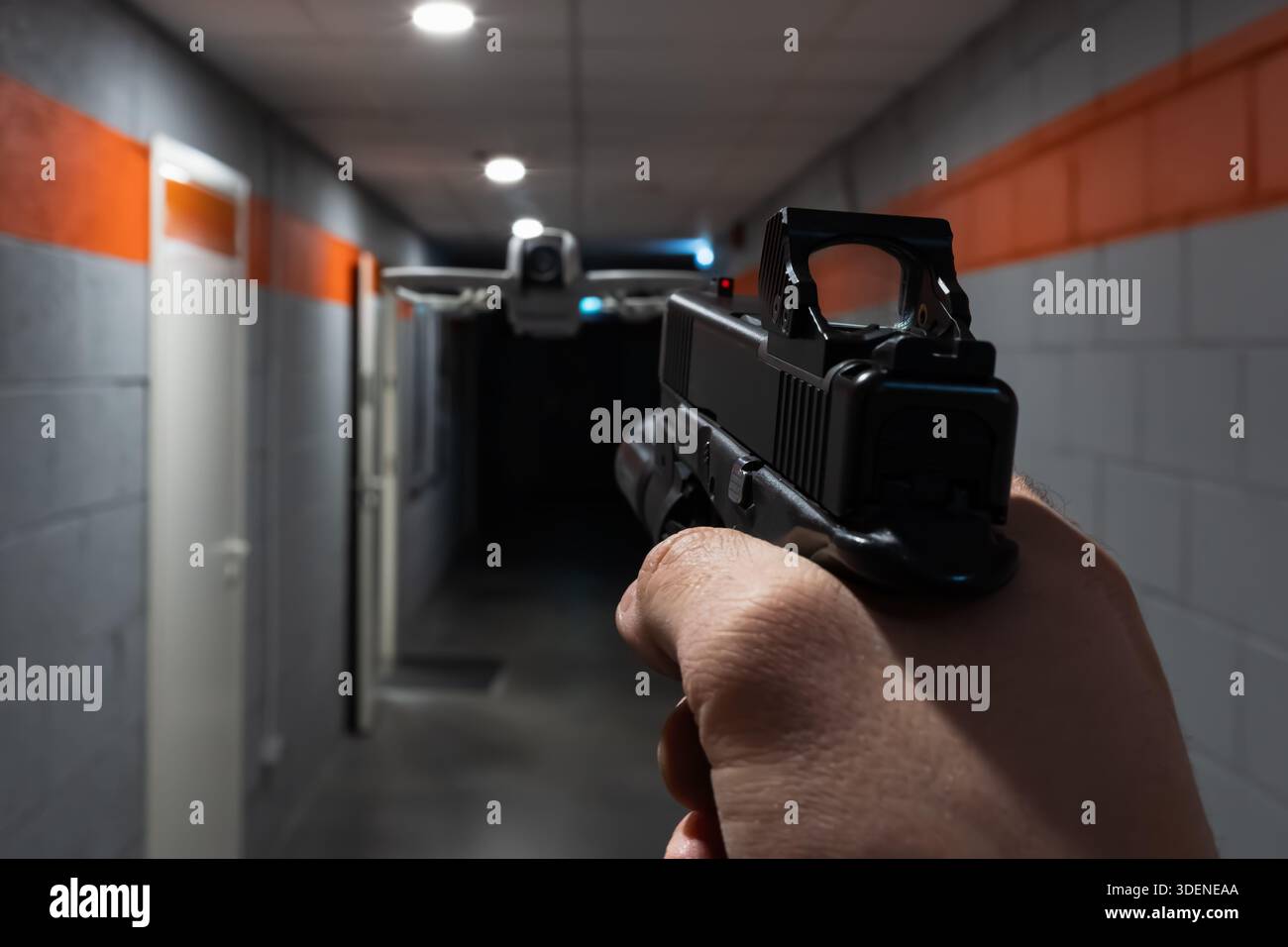 First person perspective of a man aiming a handgun with red dot sight ...