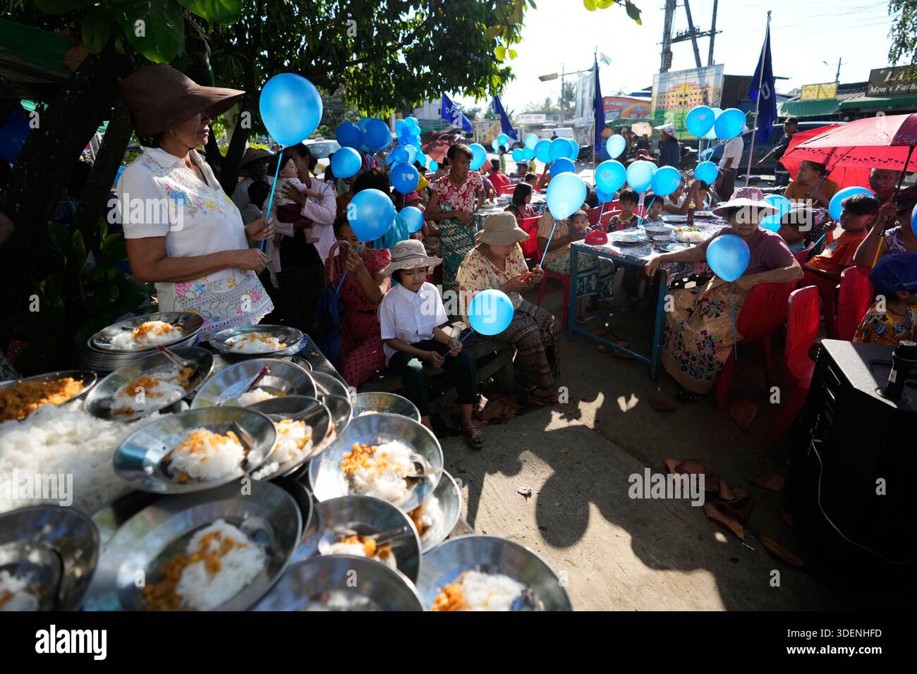 People wait to eat free food offered by the People's Pioneer Party (PPP ...