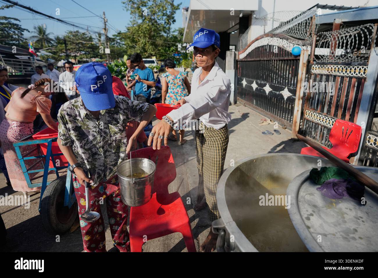 Volunteers prepare free meals offfered by the People's Pioneer Party ...