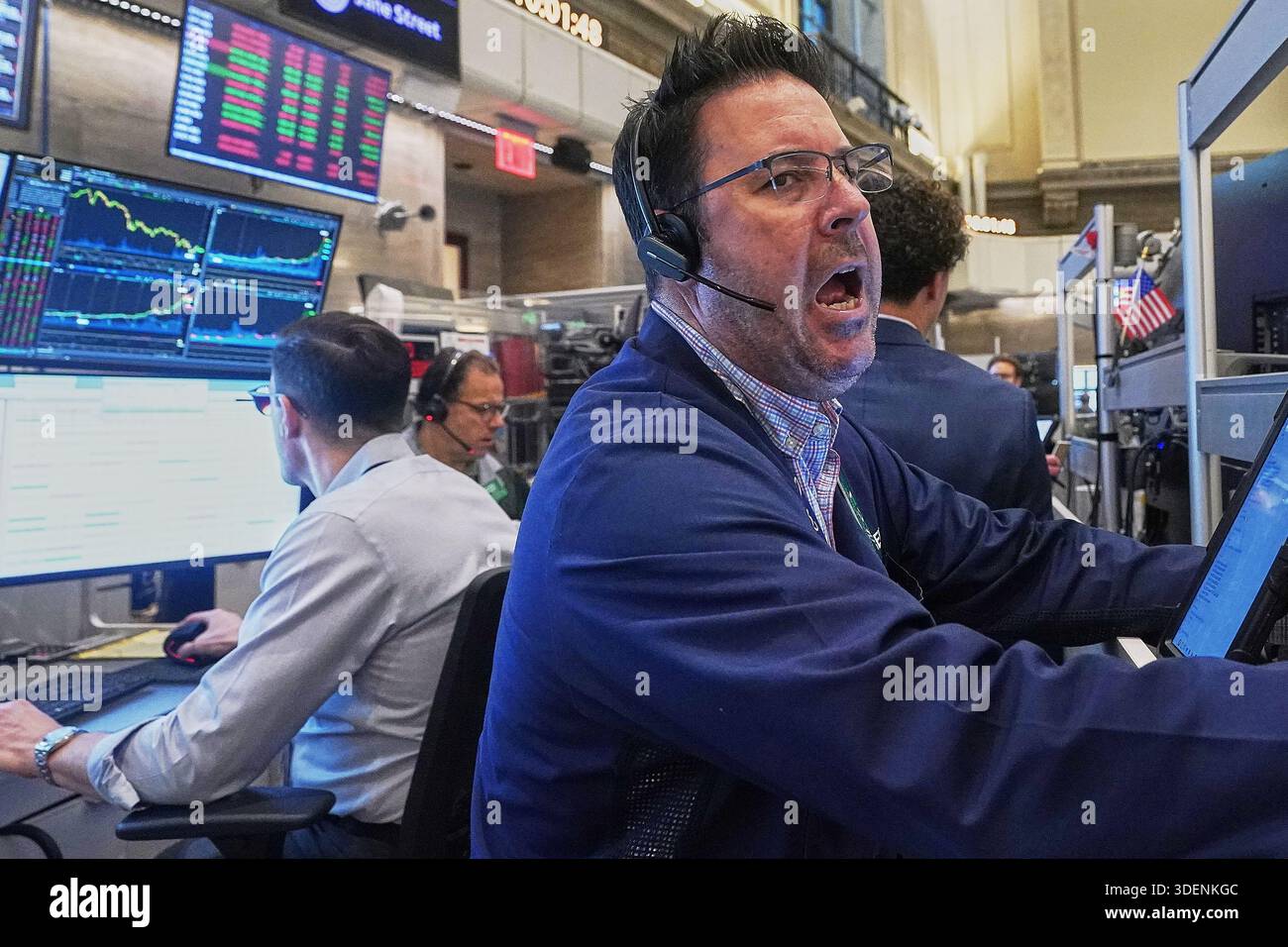 Options trader Andrew Longaro, right, works on the floor of the New ...