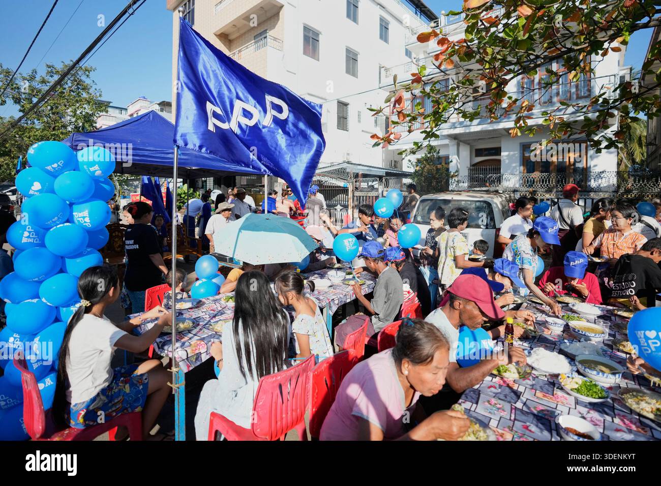 People eat free meals offered by the People's Pioneer Party (PPP ...
